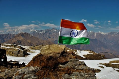 Hoisting the Indian flag at Zero Point on Khaliya top trek - Munsiyari