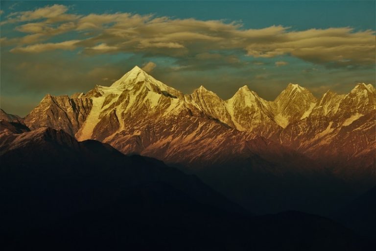 Hoisting the Indian flag at Zero Point on Khaliya top trek - Munsiyari