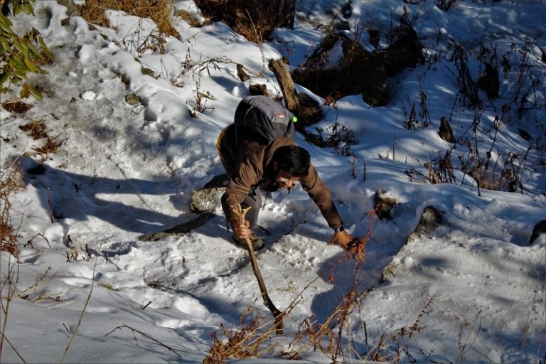 Hoisting the Indian flag at Zero Point on Khaliya top trek - Munsiyari