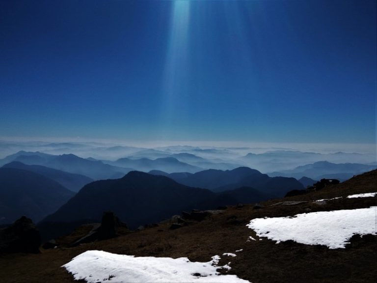 Hoisting the Indian flag at Zero Point on Khaliya top trek - Munsiyari