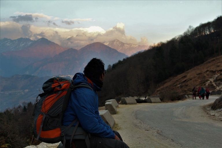 Hoisting the Indian flag at Zero Point on Khaliya top trek - Munsiyari