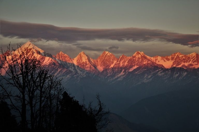 Hoisting the Indian flag at Zero Point on Khaliya top trek - Munsiyari